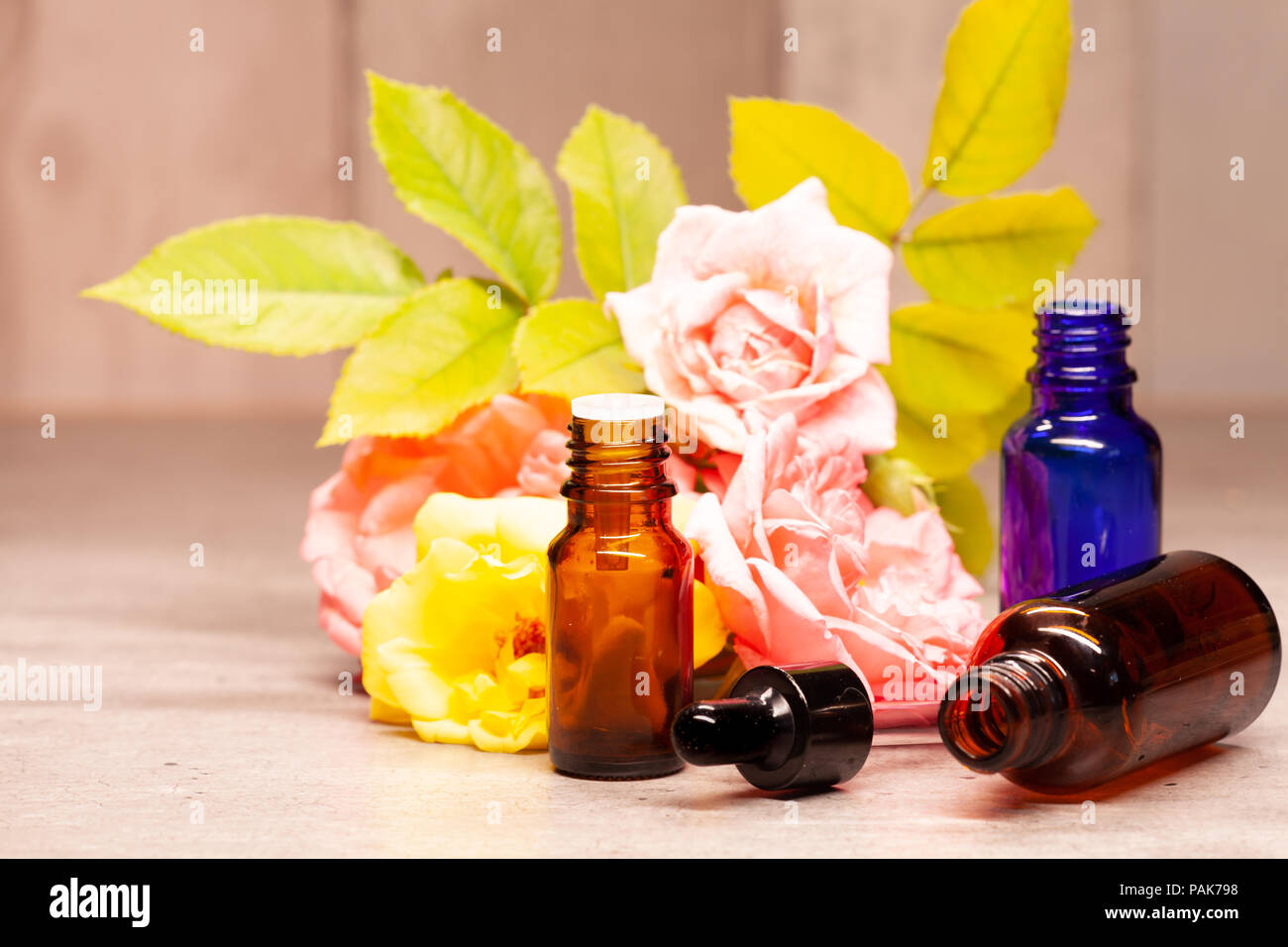 rose flowers and bottles of essential oils for aromatherapy Stock Photo ...