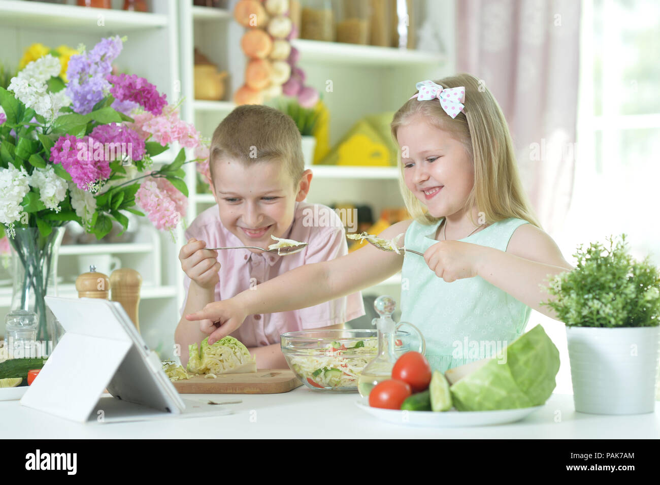 Cute little brother and sister cooking Stock Photo - Alamy