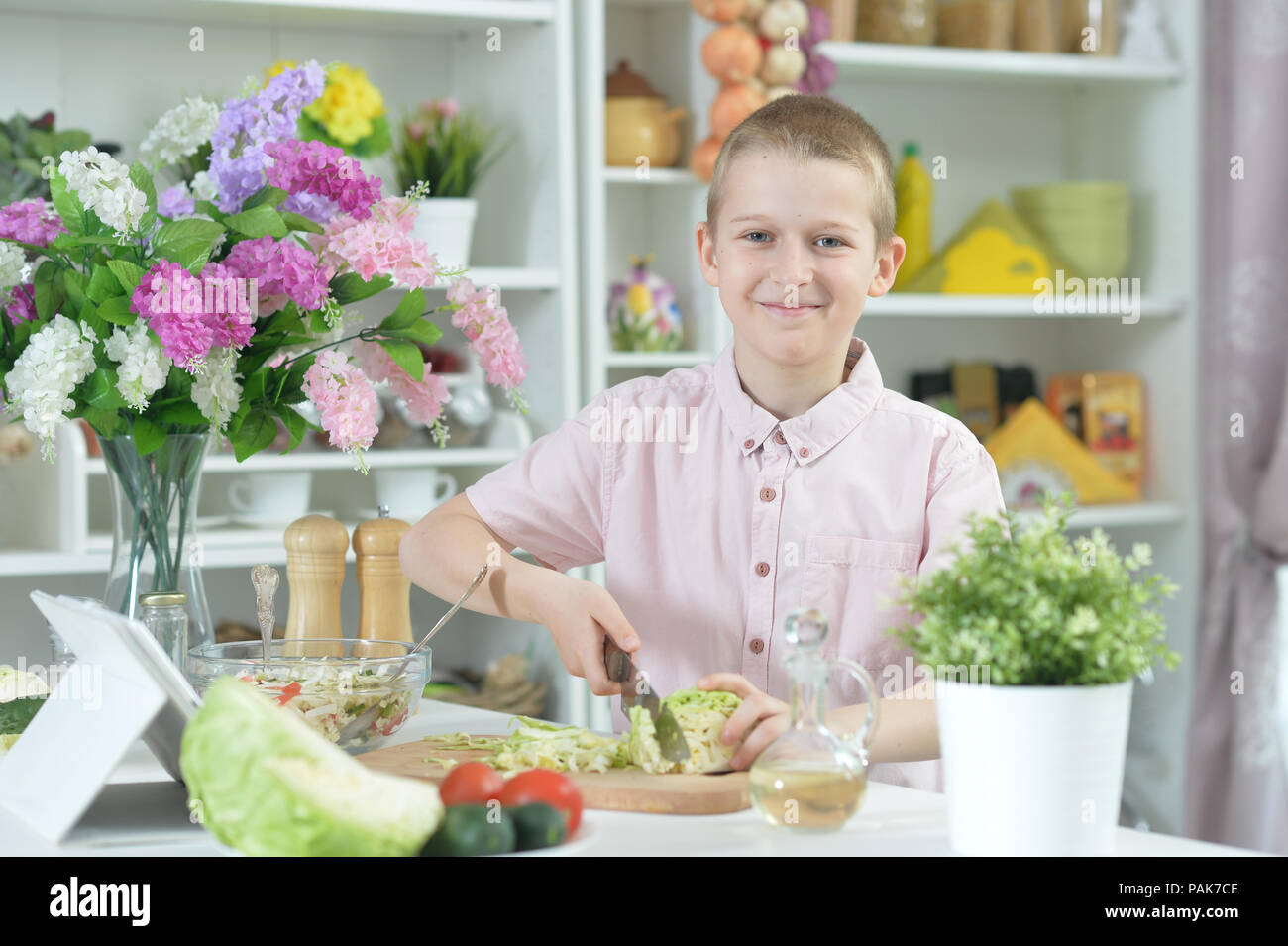Cute little boy making dinner Stock Photo - Alamy