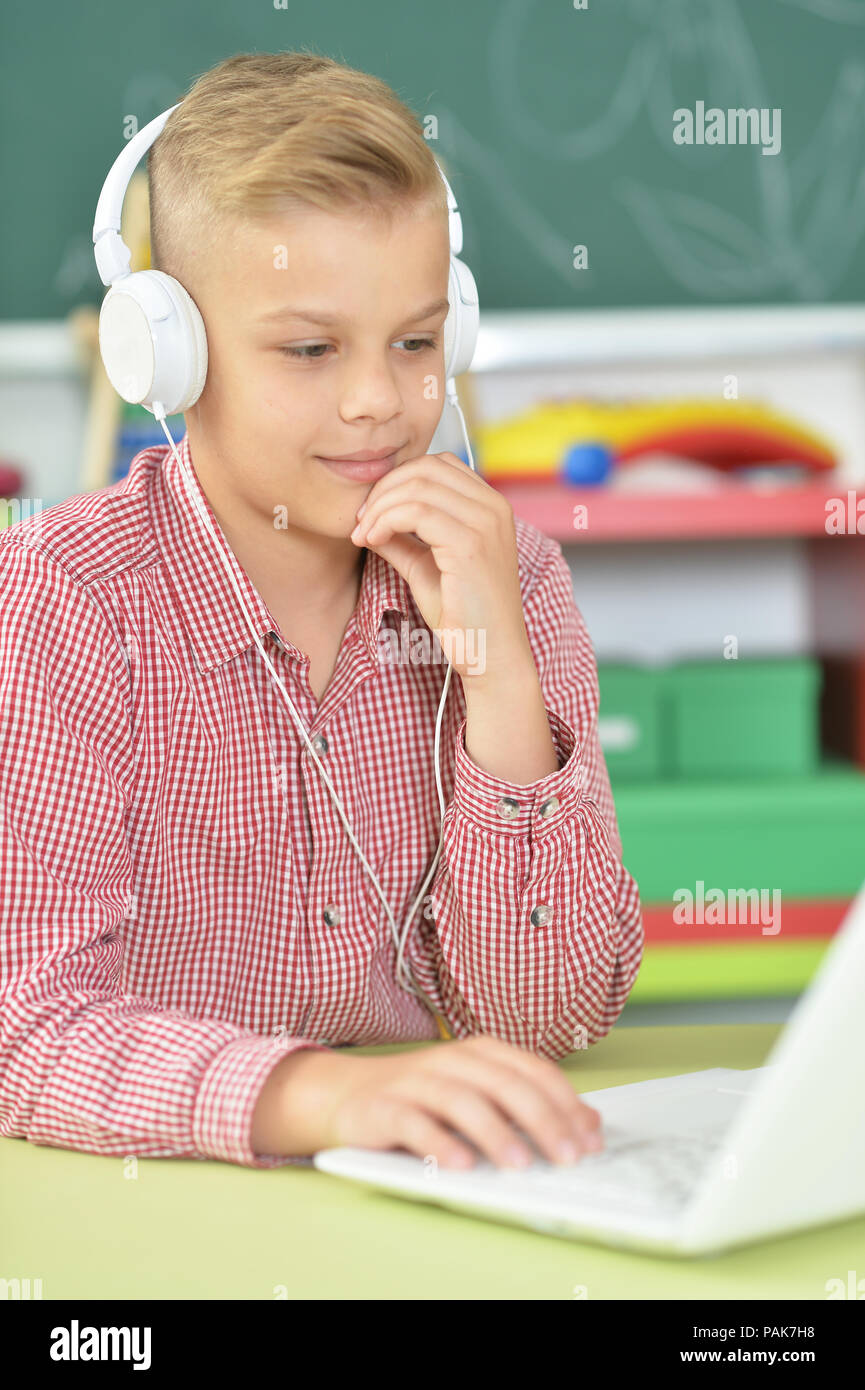 boy with headphones using laptop Stock Photo - Alamy