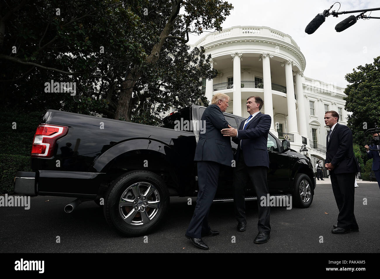 United States President Donald Trump (L) talks to Ford Motor Company ...