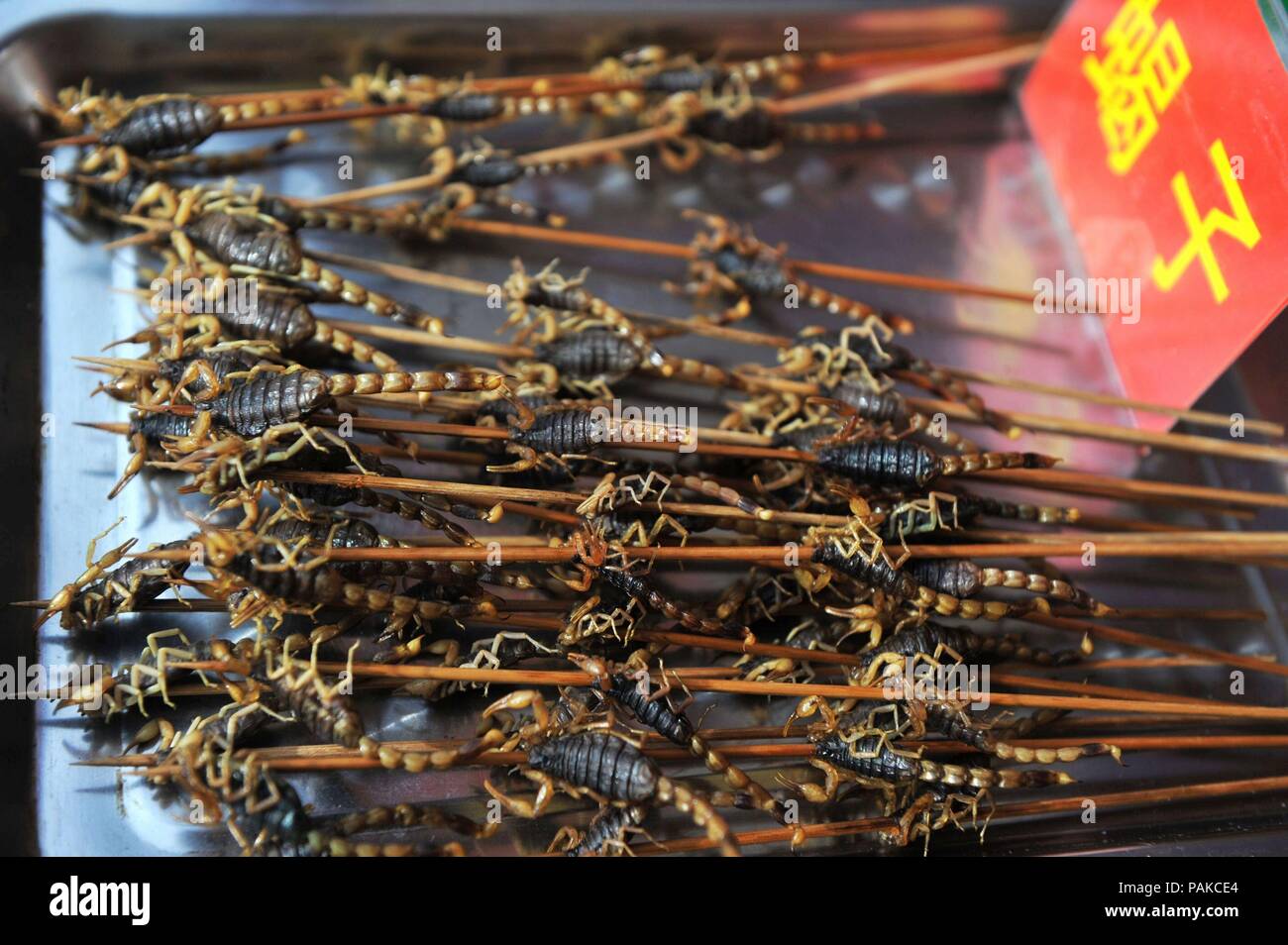 China. 24th July, 2018. Qingdao, CHINA-Fried insects including ...