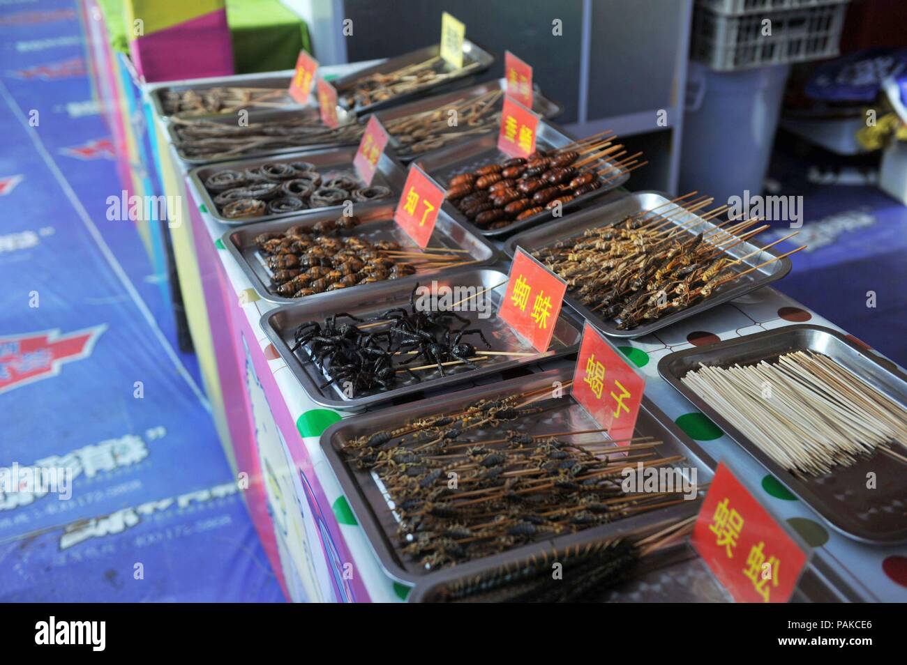 China. 24th July, 2018. Qingdao, CHINA-Fried insects including ...