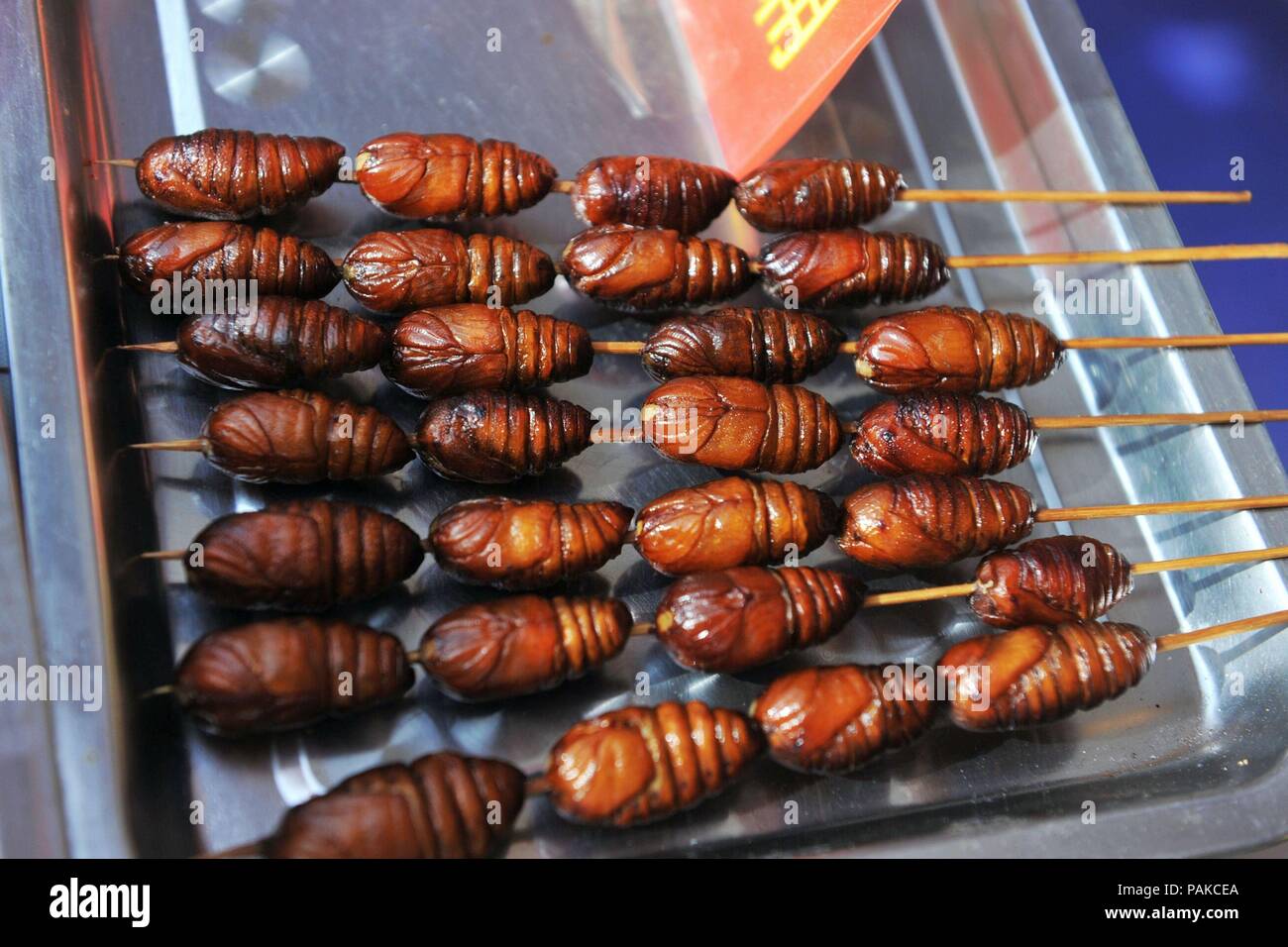 China. 24th July, 2018. Qingdao, CHINA-Fried insects including ...