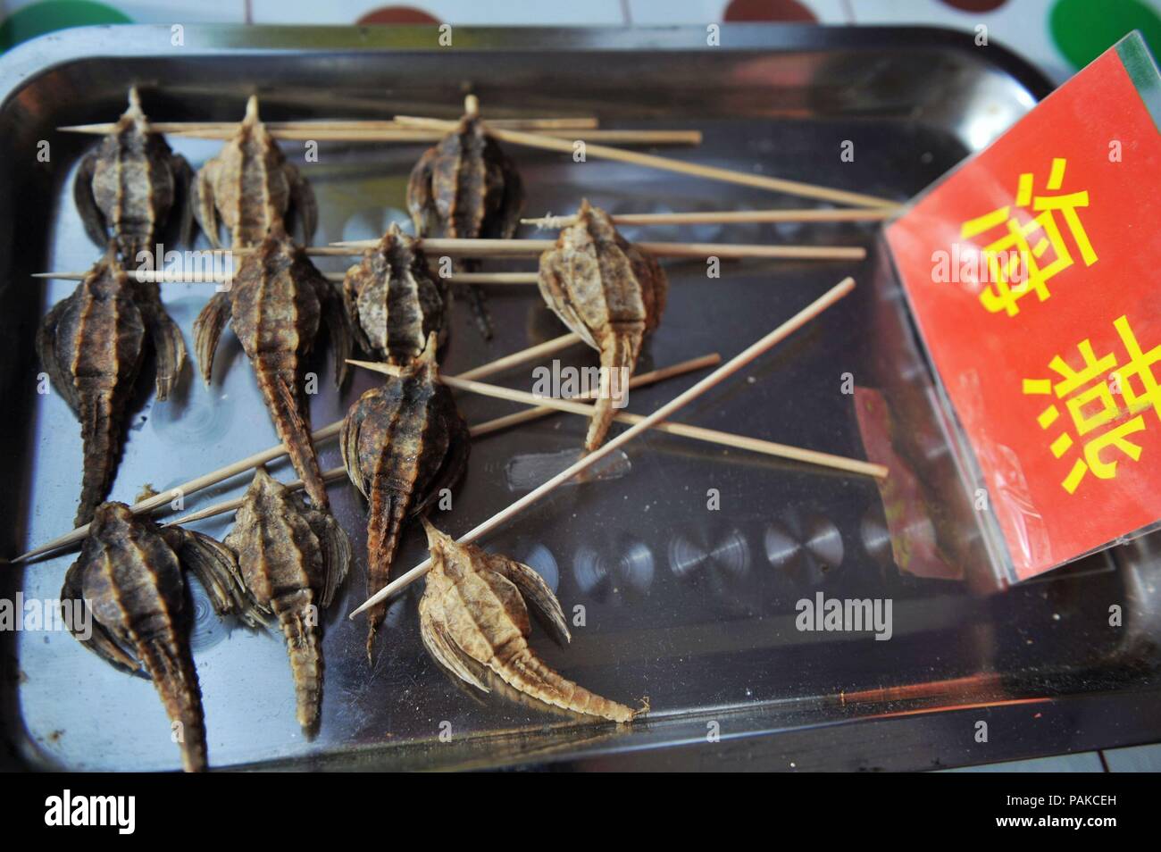 China. 24th July, 2018. Qingdao, CHINA-Fried insects including ...
