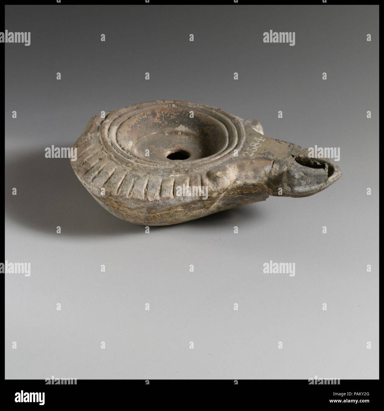 Lamp. Culture: Roman. Dimensions: Length: 3 9/16 in. (9.1 cm) Height: 1 ...