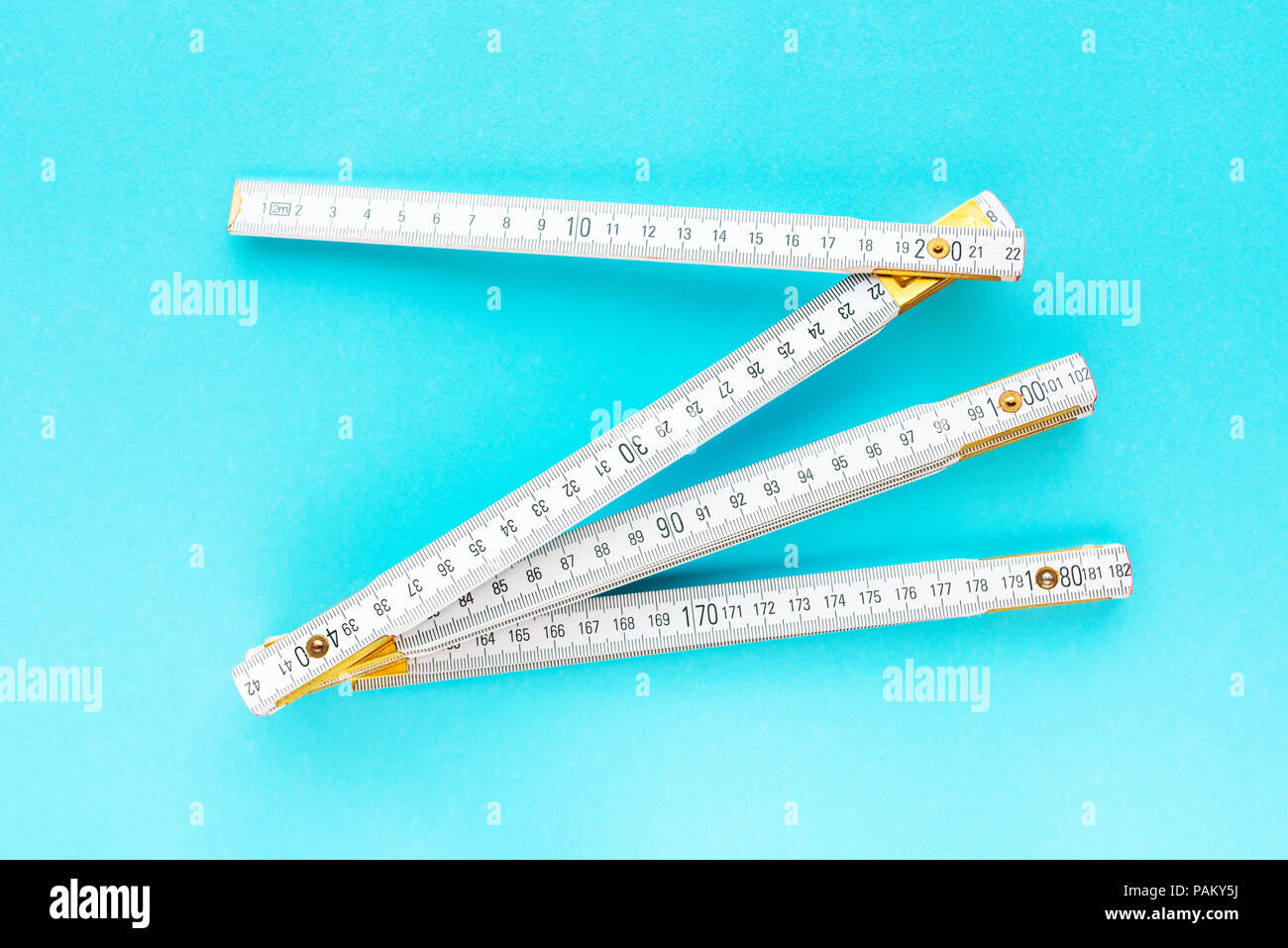 Wood carpenter folding ruler on blue background Stock Photo - Alamy