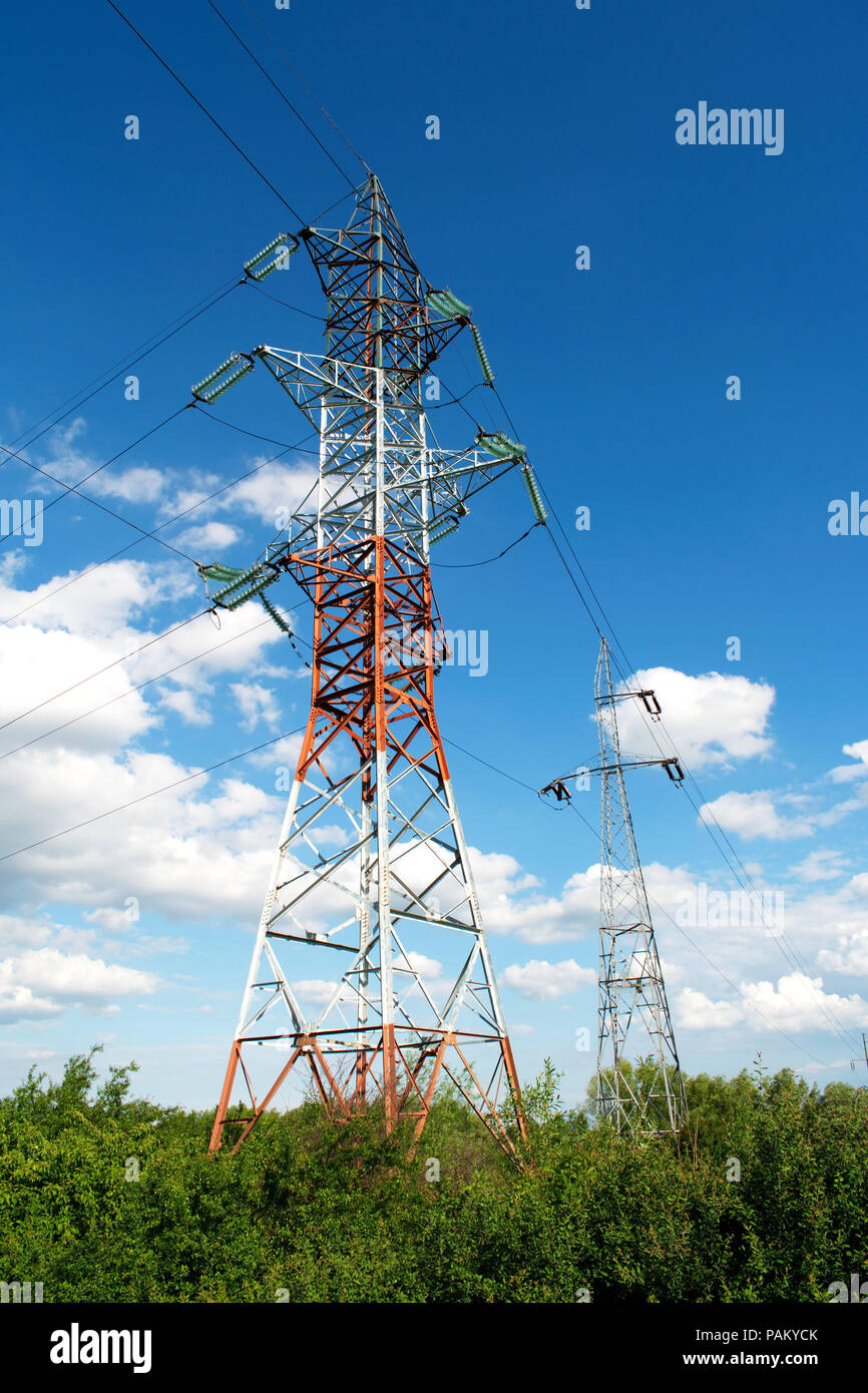 High voltage poles and the blue sky with clouds Stock Photo - Alamy