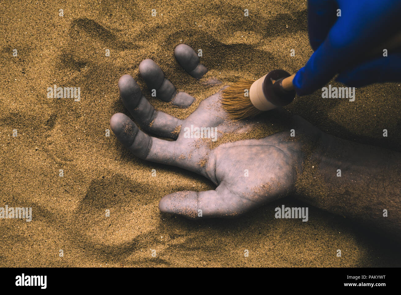 Forensic expert discovering dead body buried in desert sand. Conceptual ...