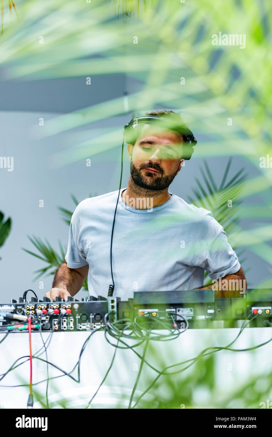 Photo of adult dj working with his equipment Stock Photo - Alamy