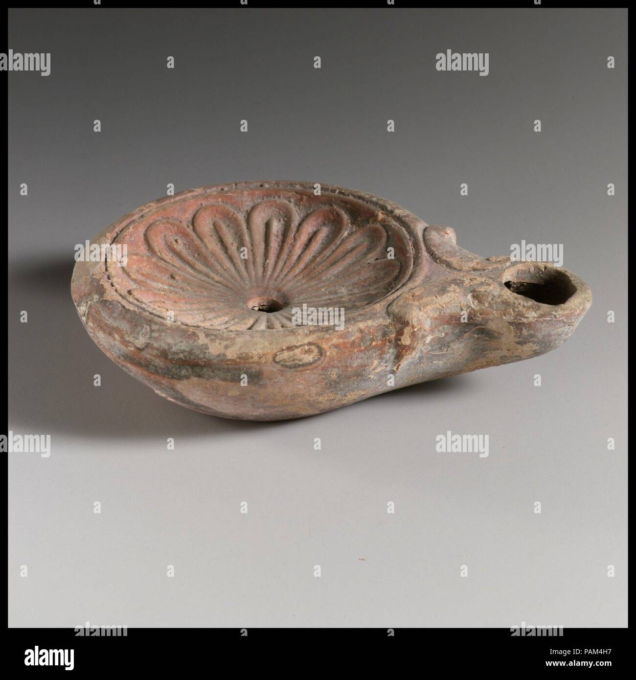 Lamp. Culture: Roman. Dimensions: Length: 3 15/16 in. (10 cm) Height: 1 ...