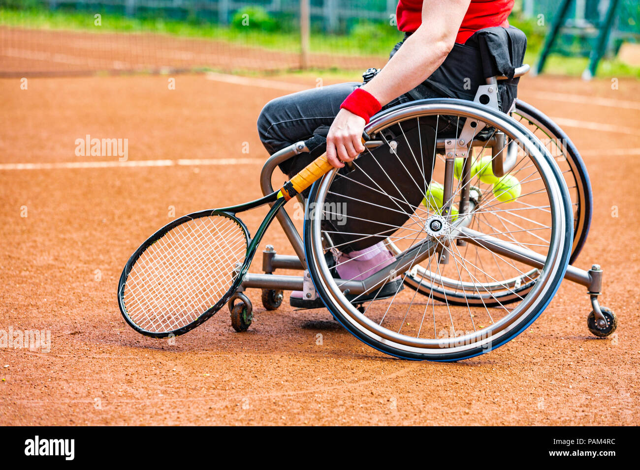 Disabled young woman on wheelchair playing tennis on tennis court Stock ...
