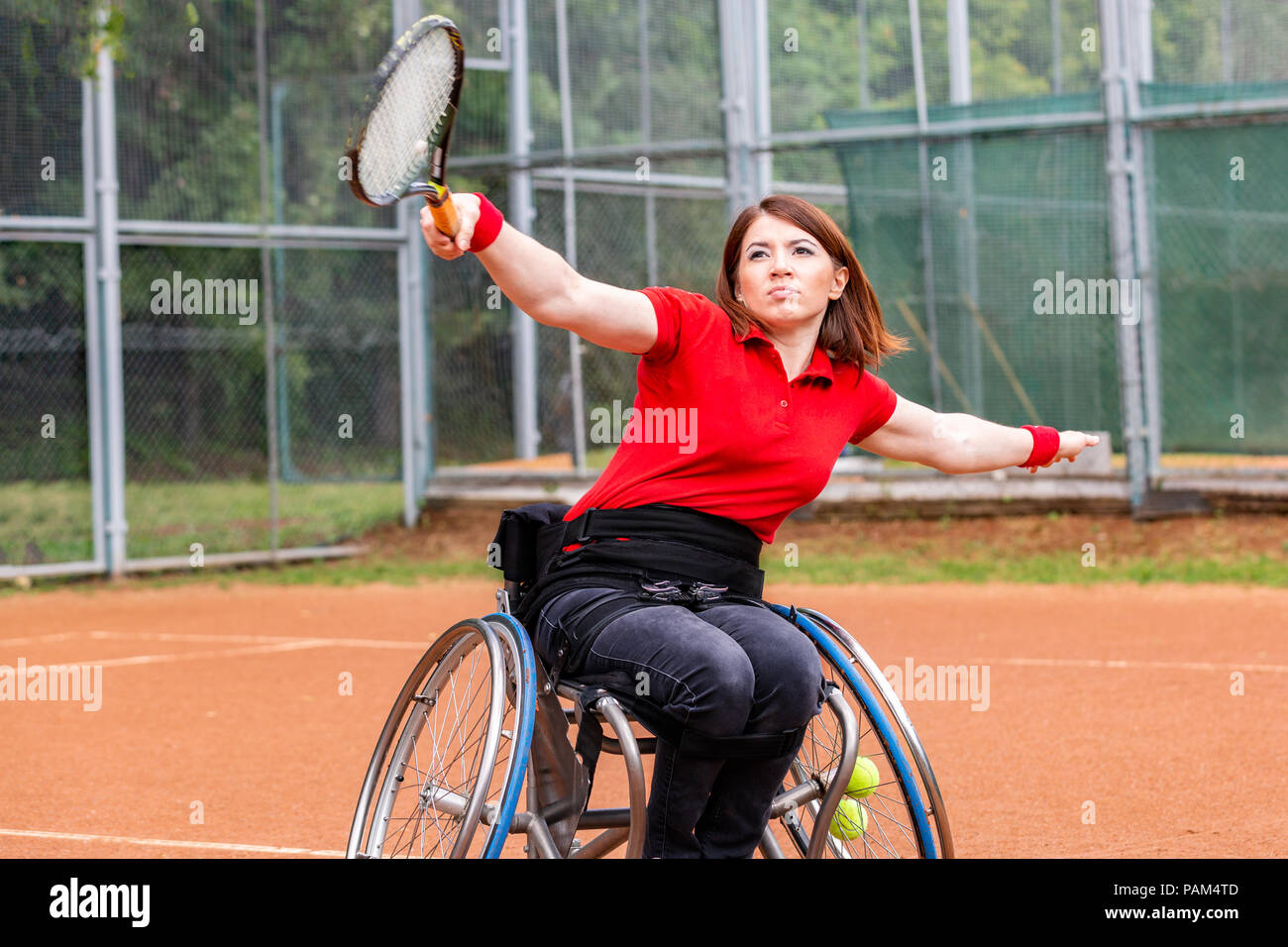 Disabled young woman on wheelchair playing tennis on tennis court Stock ...