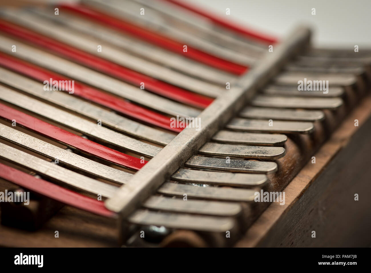 Details of a thumb piano (Kalimba, Mbira) with silver and red tines ...