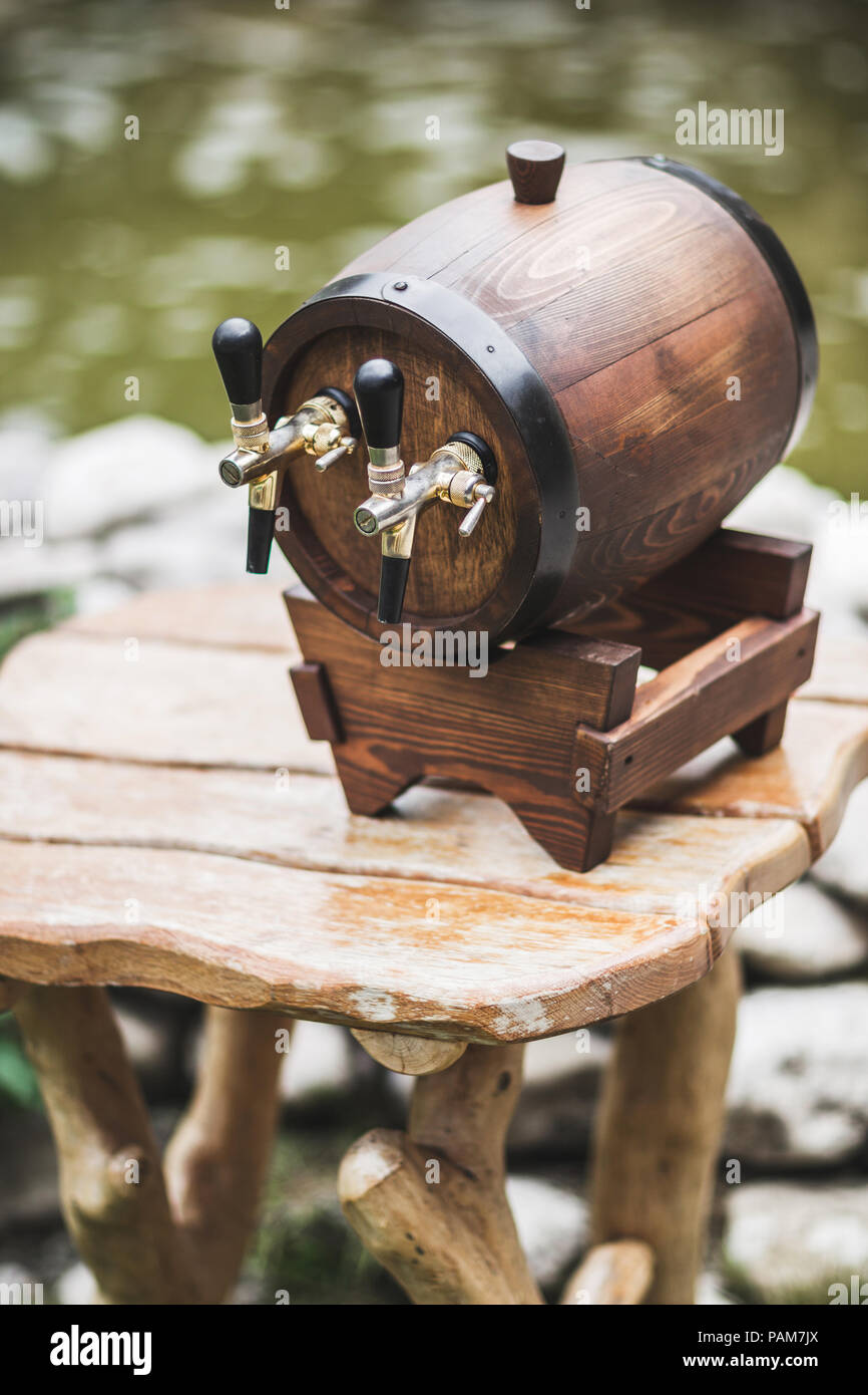 Wooden beer keg with a two tap on table Stock Photo - Alamy