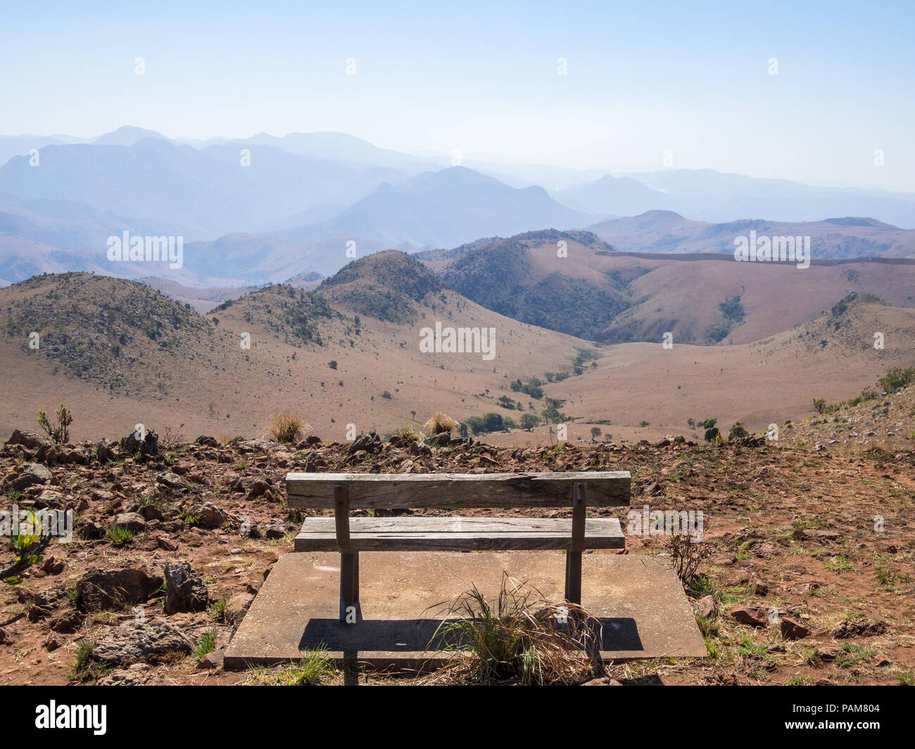 Empty wooden bench overlooking mountains and arid landscape of ...