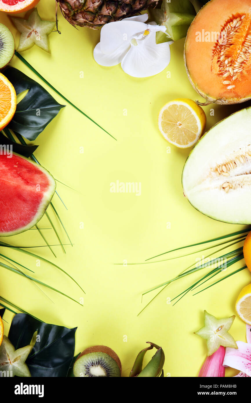 Tropical fruit. Assortment of tropical fruits with leaves of palm trees ...