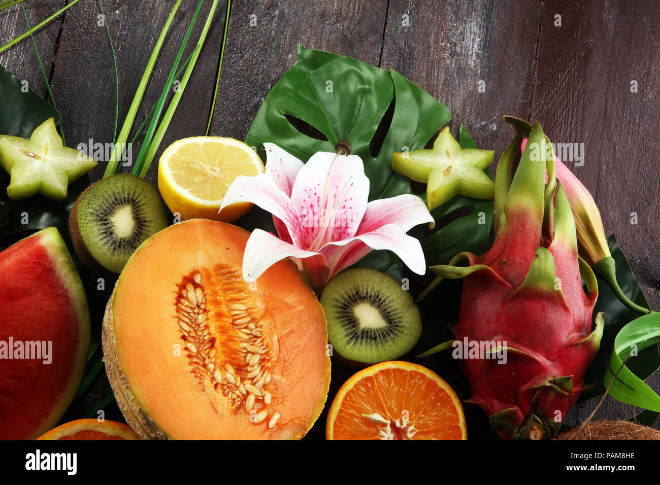 Tropical fruit. Assortment of tropical fruits with leaves of palm trees ...