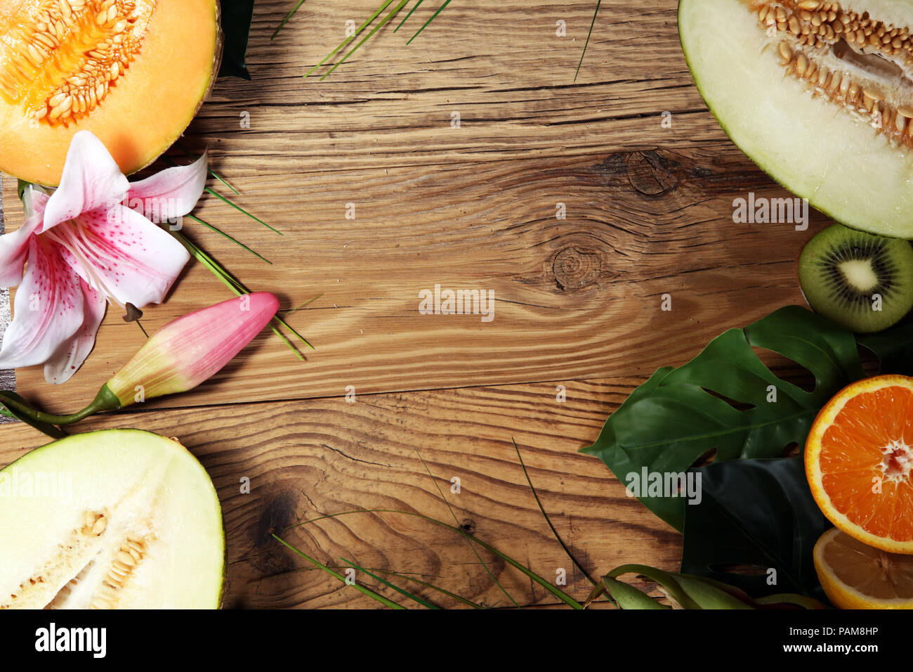 Tropical fruit. Assortment of tropical fruits with leaves of palm trees ...