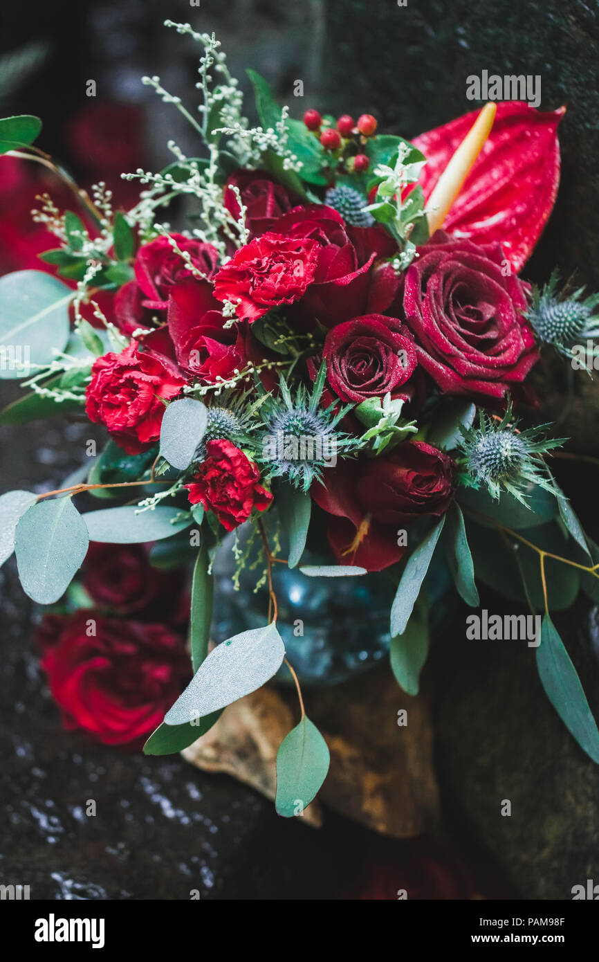 Wedding decorations with fresh red and vinous color flowers close up ...