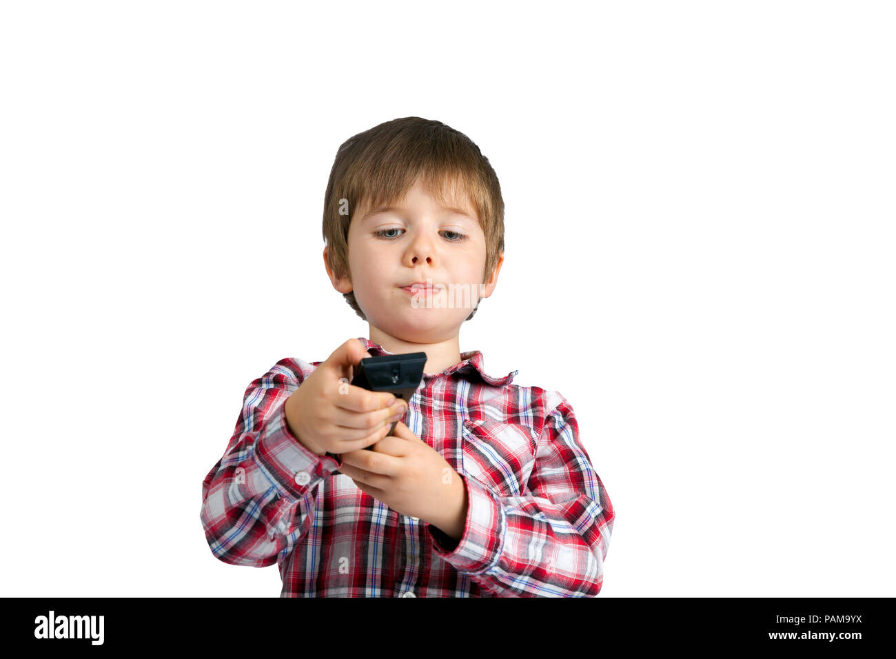 A little boy holds a remote control. He looks like he is really ...