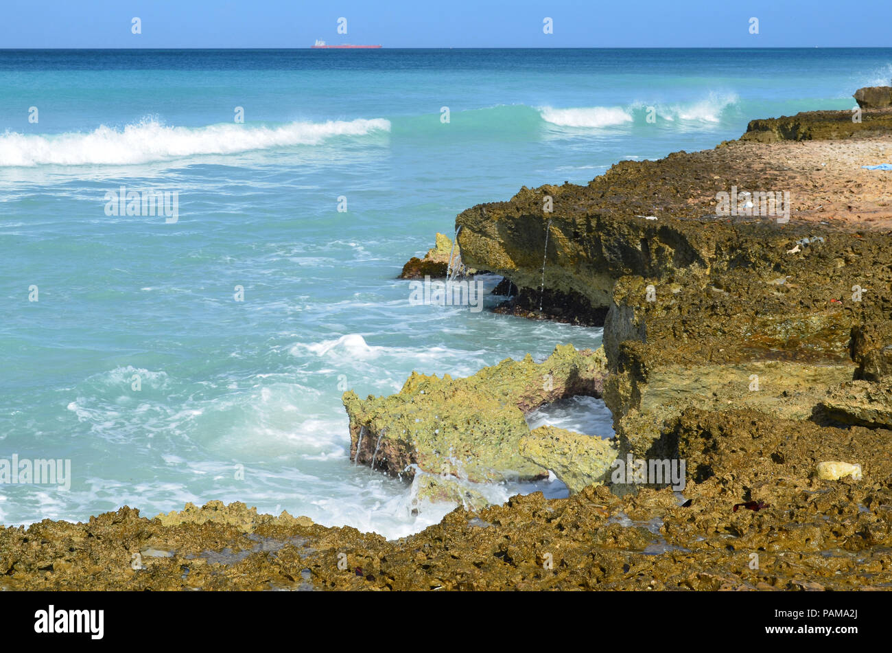 Coastal Aruba with ocean waves crashing on sharp jagged rocks Stock ...