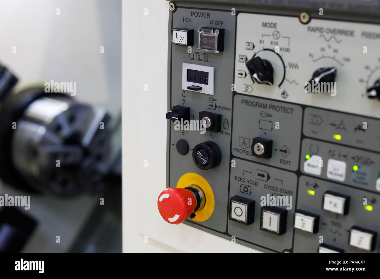 CNC turning center with a control panel on the foreground. Selective ...