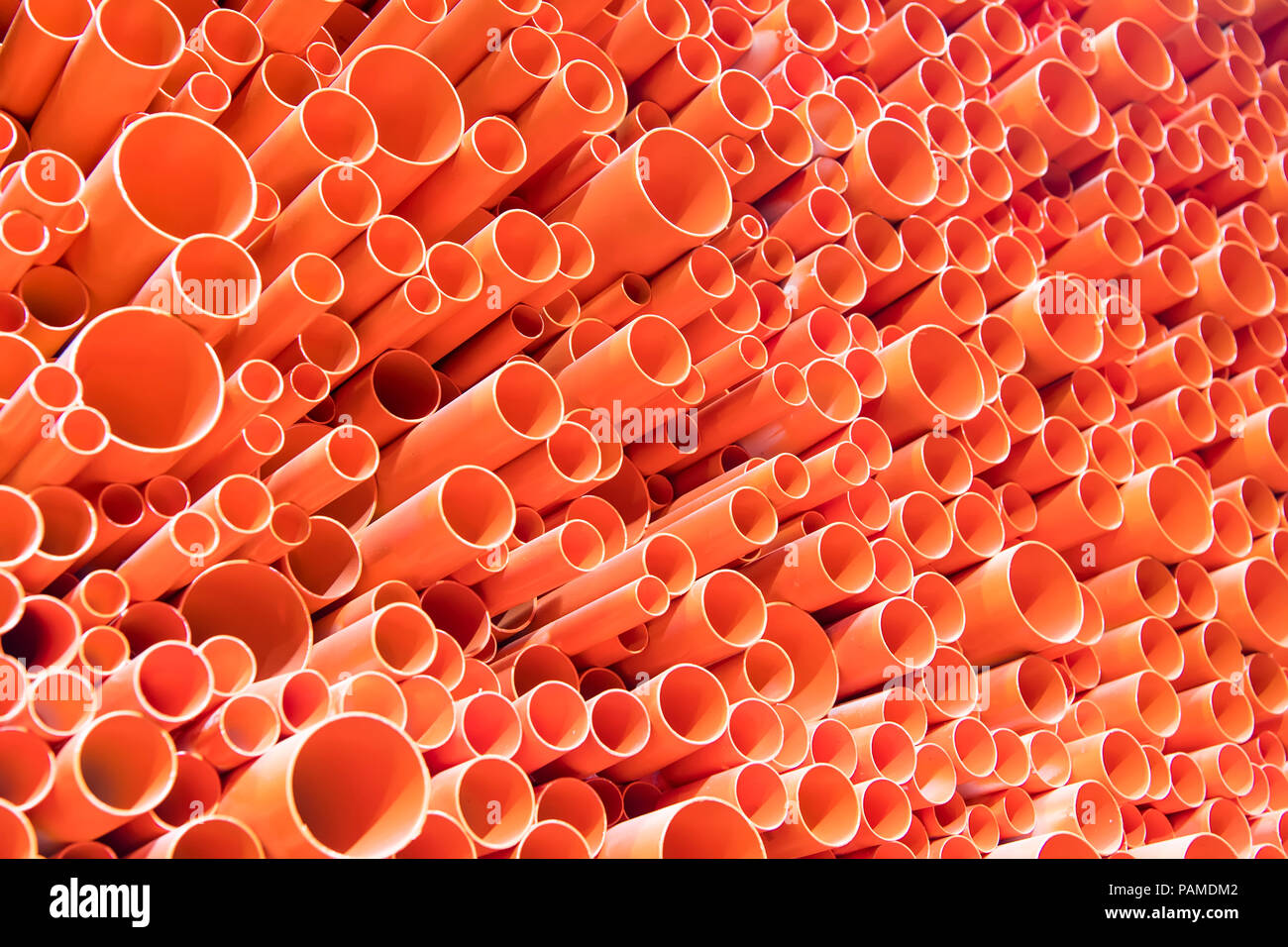orange PVC pipes stacked in construction site Stock Photo - Alamy
