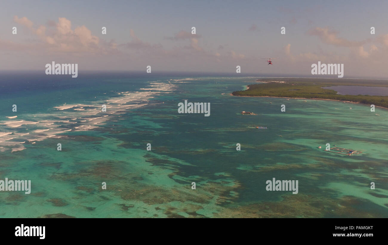 Sea shore with a flying helicopter from above Stock Photo - Alamy