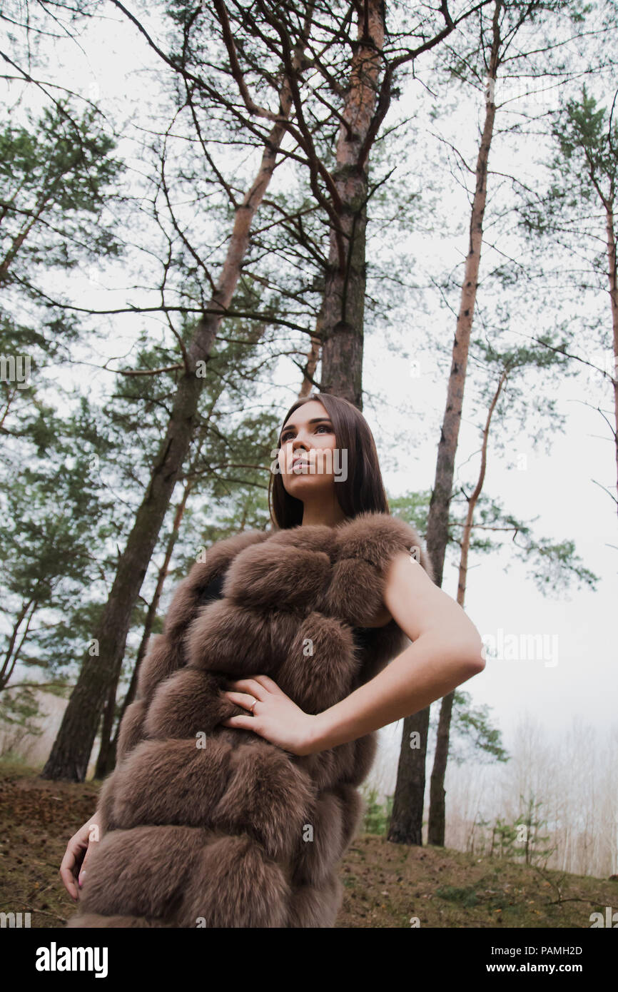 Portrait of a very beautiful girl in a forest dressed in fur Stock ...