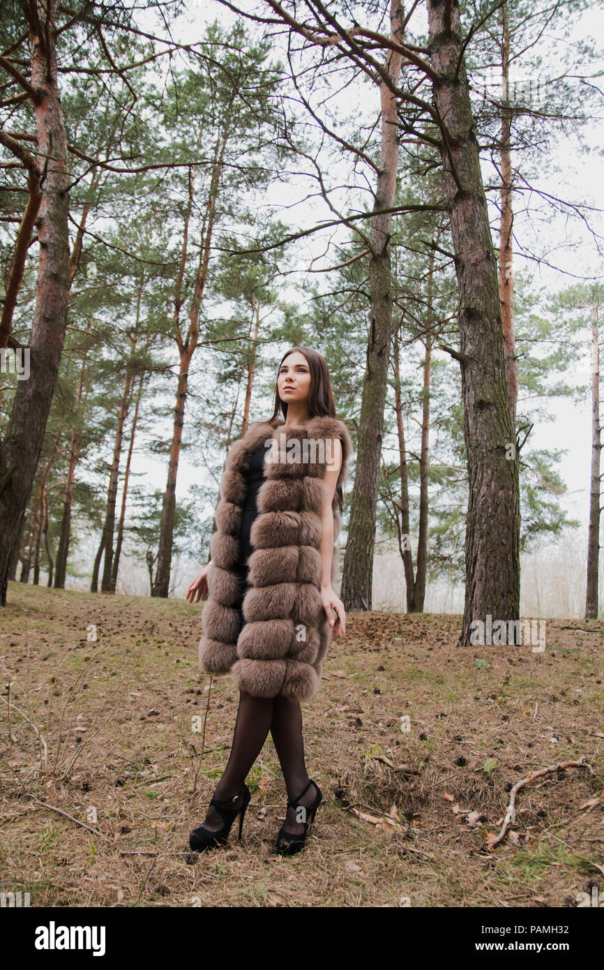 Portrait of a very beautiful girl in a forest dressed in fur Stock ...