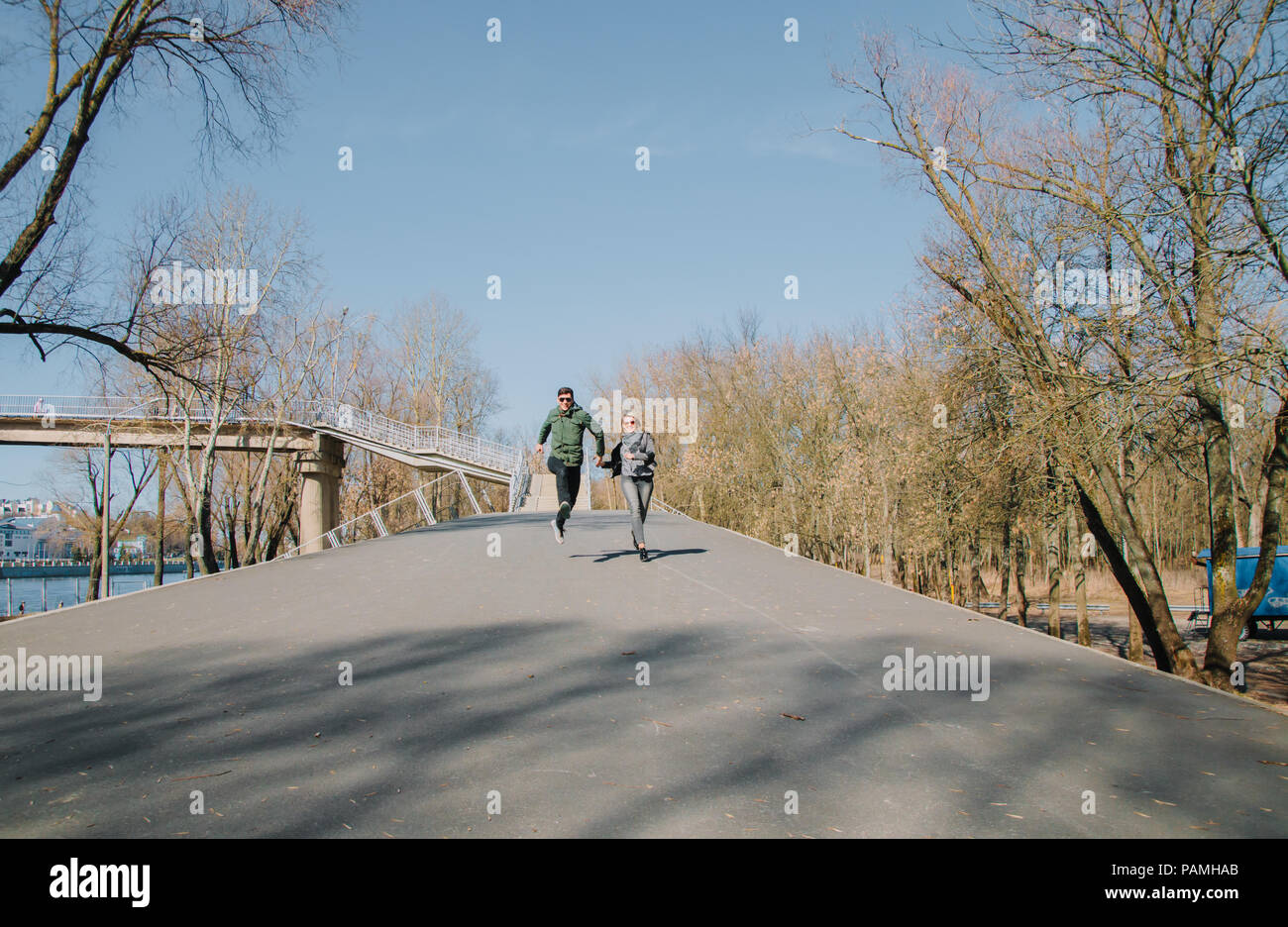 Cheerful loving each other couple kisses. Walk in the park and hug ...