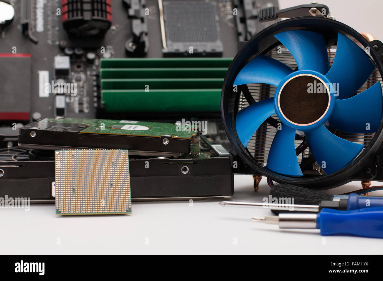 Computer assembly details and tools on a white background Stock Photo ...
