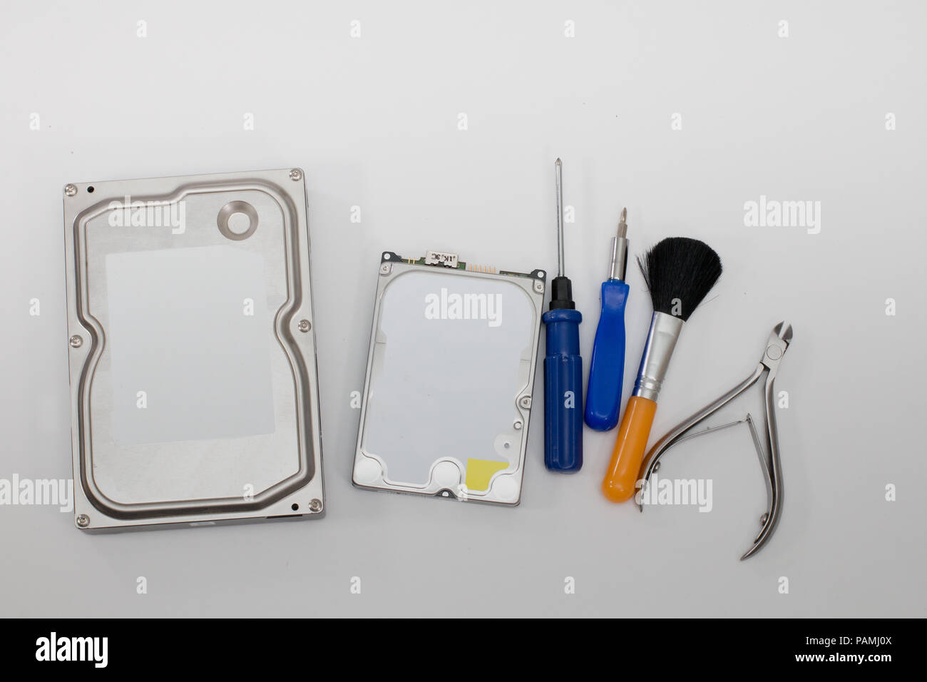 Hard disks prepared for disassembly and tools for this Stock Photo - Alamy