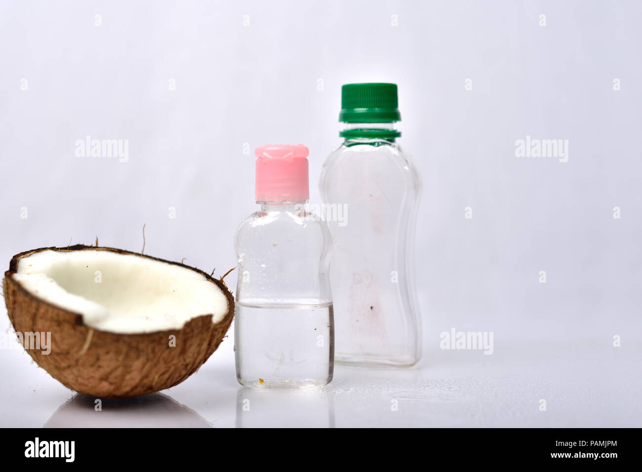 Coconut oil with coconut on white background Stock Photo - Alamy