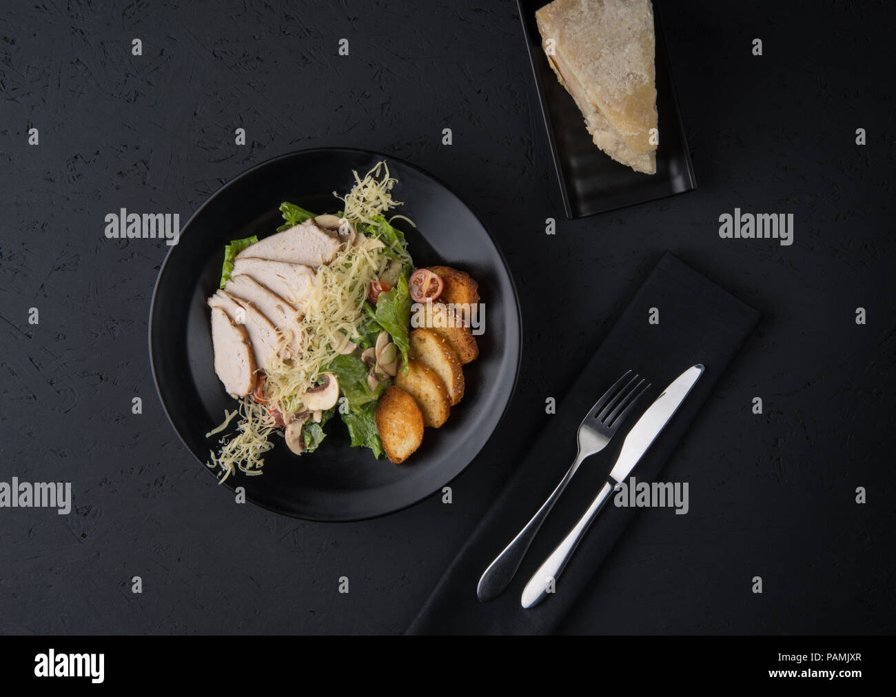 a dish of chicken on the black wooden surface, top view Stock Photo - Alamy