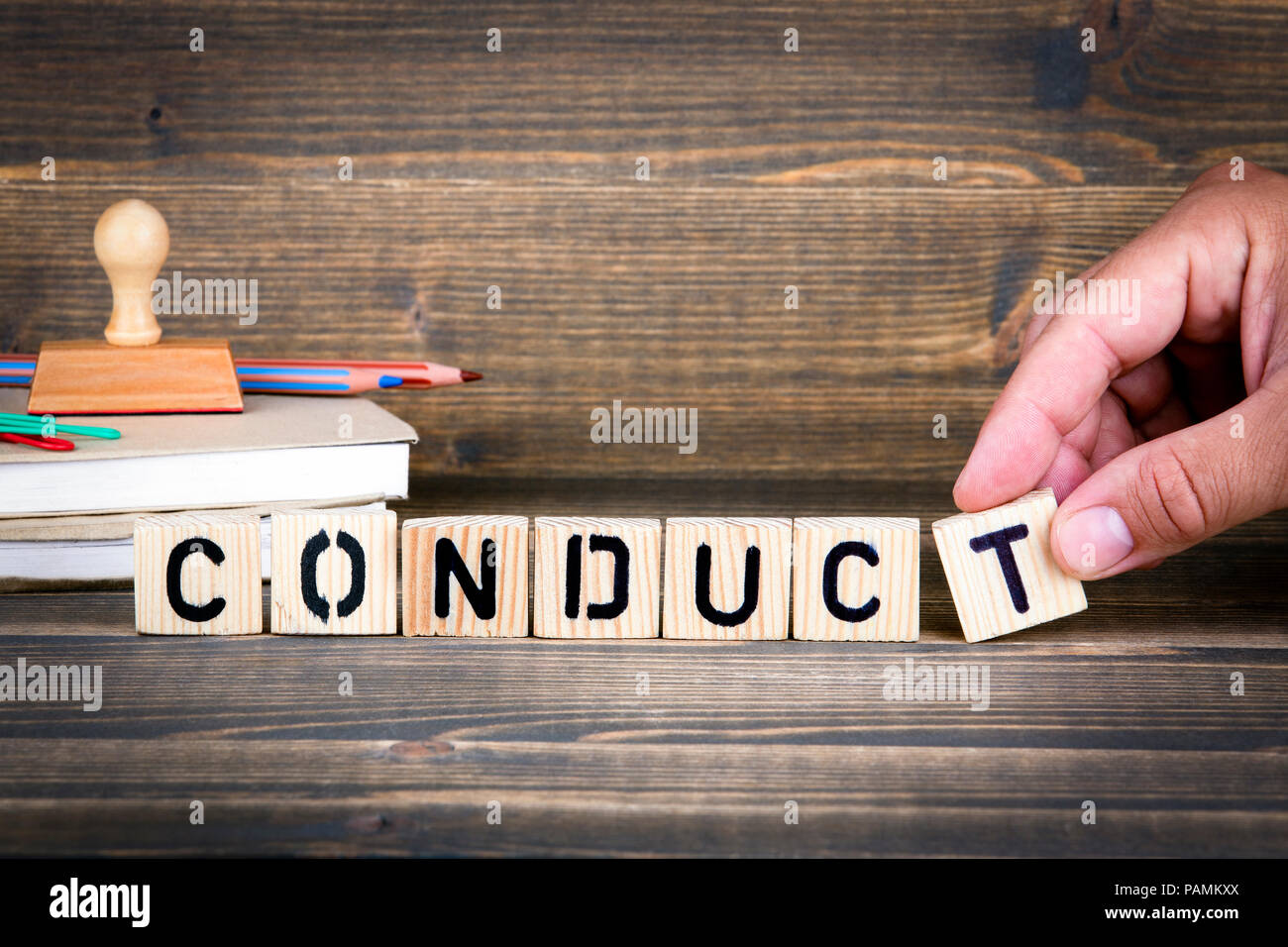 conduct. Wooden letters on the office desk Stock Photo - Alamy