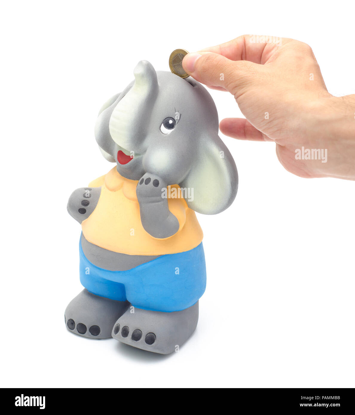 Putting a coin in an elephant piggy bank Stock Photo - Alamy