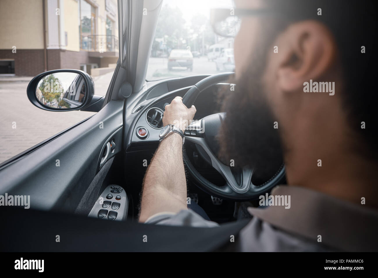 Man Looking In Rearview Mirror