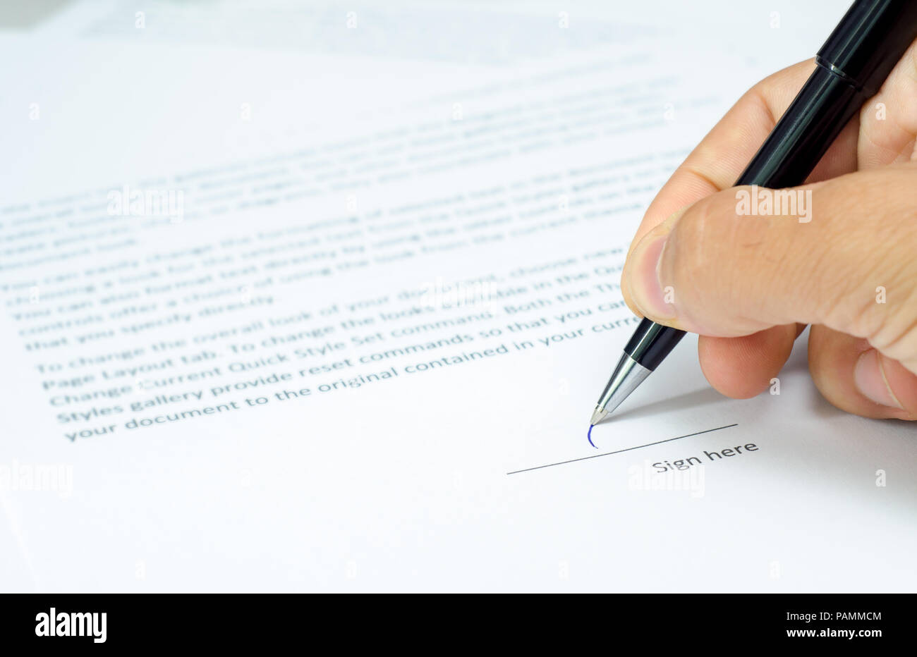 A hand signing a document Stock Photo - Alamy