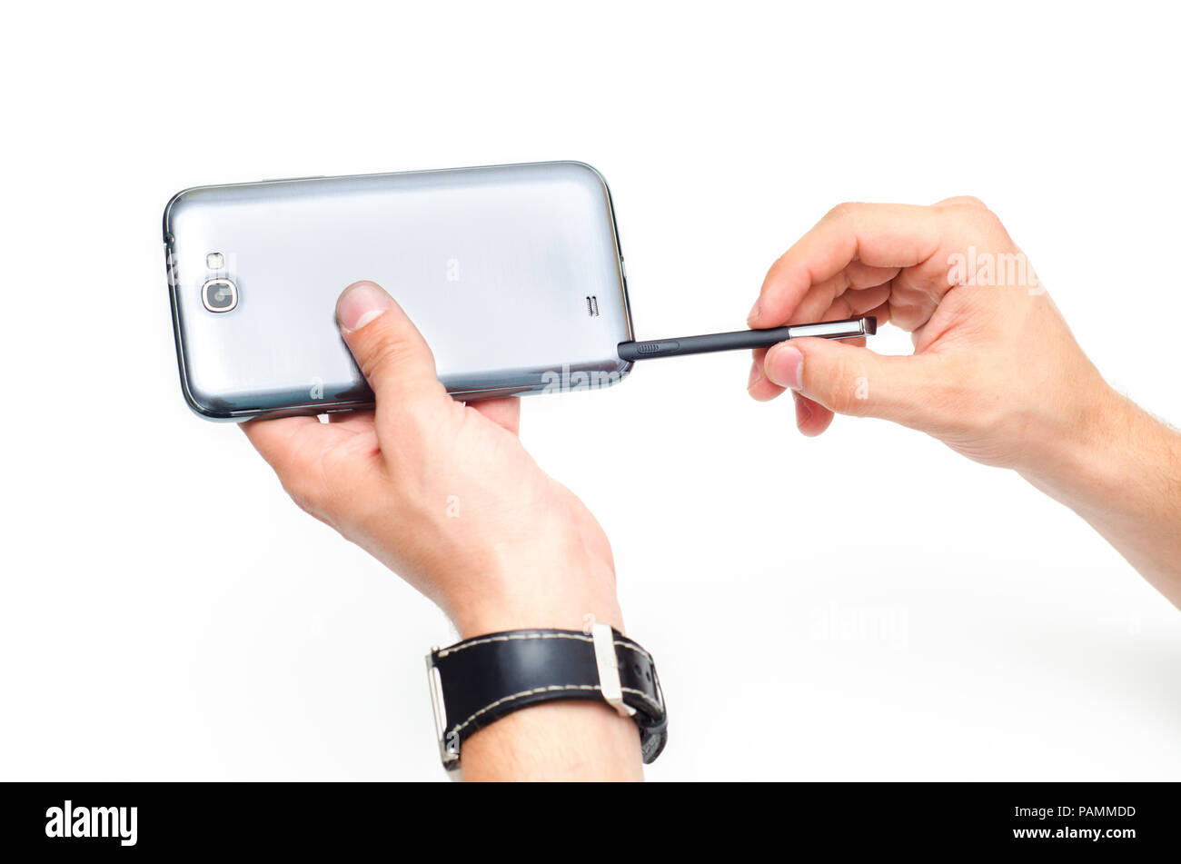 Two hands grabbing a stylus from a large screen smartphone Stock Photo ...