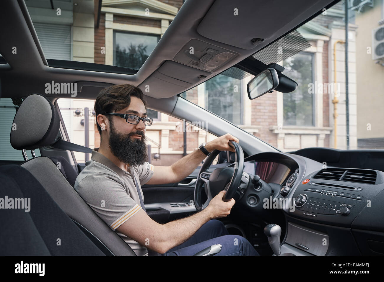 Young ethnic man driving car hi-res stock photography and images - Alamy