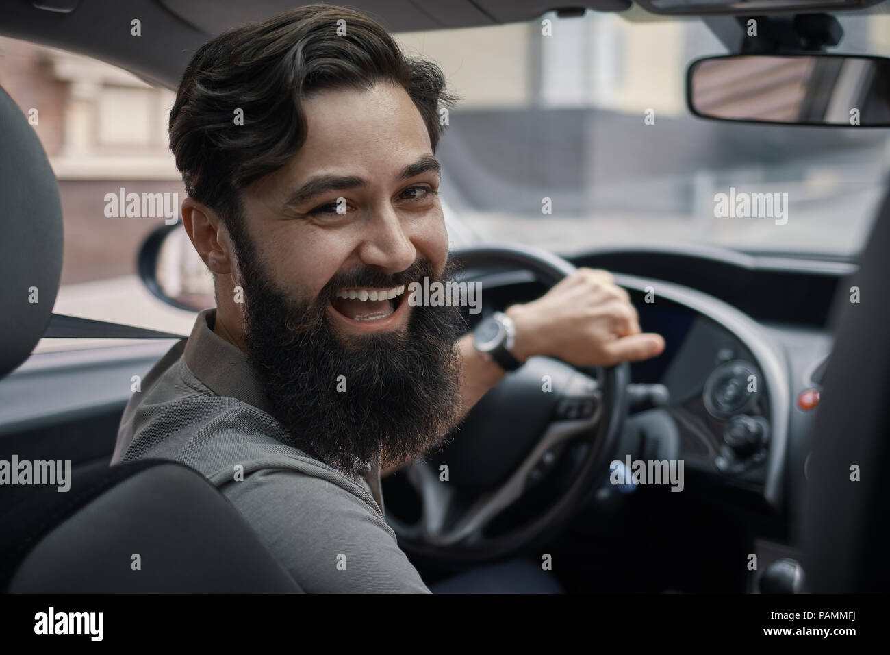 Young ethnic man driving car hi-res stock photography and images - Alamy