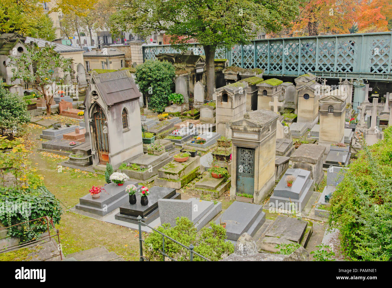 old worn grave tombs with autumn trees in Mont martre cemetery, Paris ...