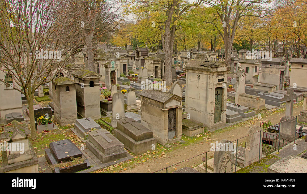 old worn grave tombs with autumn trees in Mont martre cemetery, Paris ...