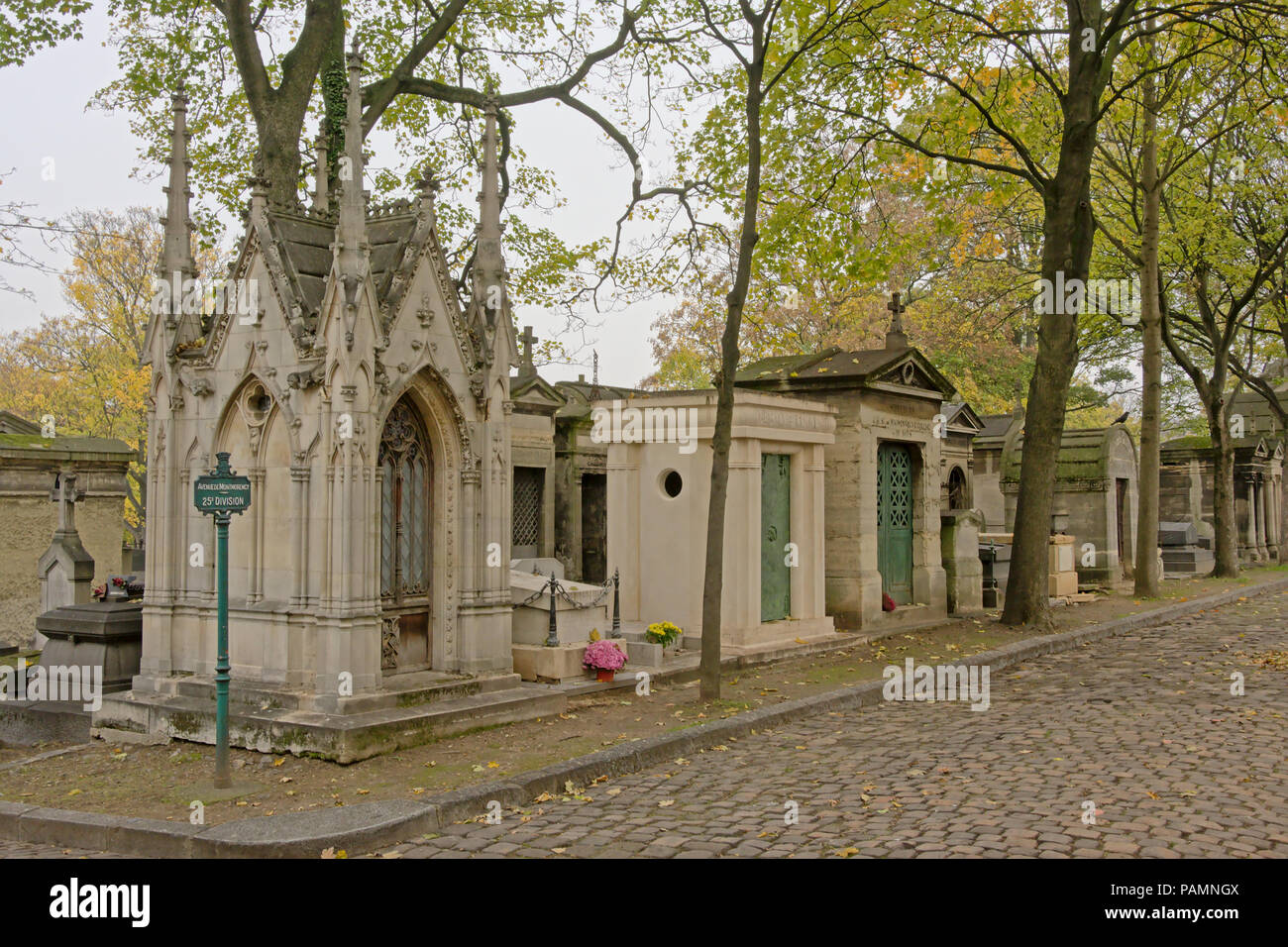 Old grave tombs along lanes with autumn trees in Mont martre cemetery ...
