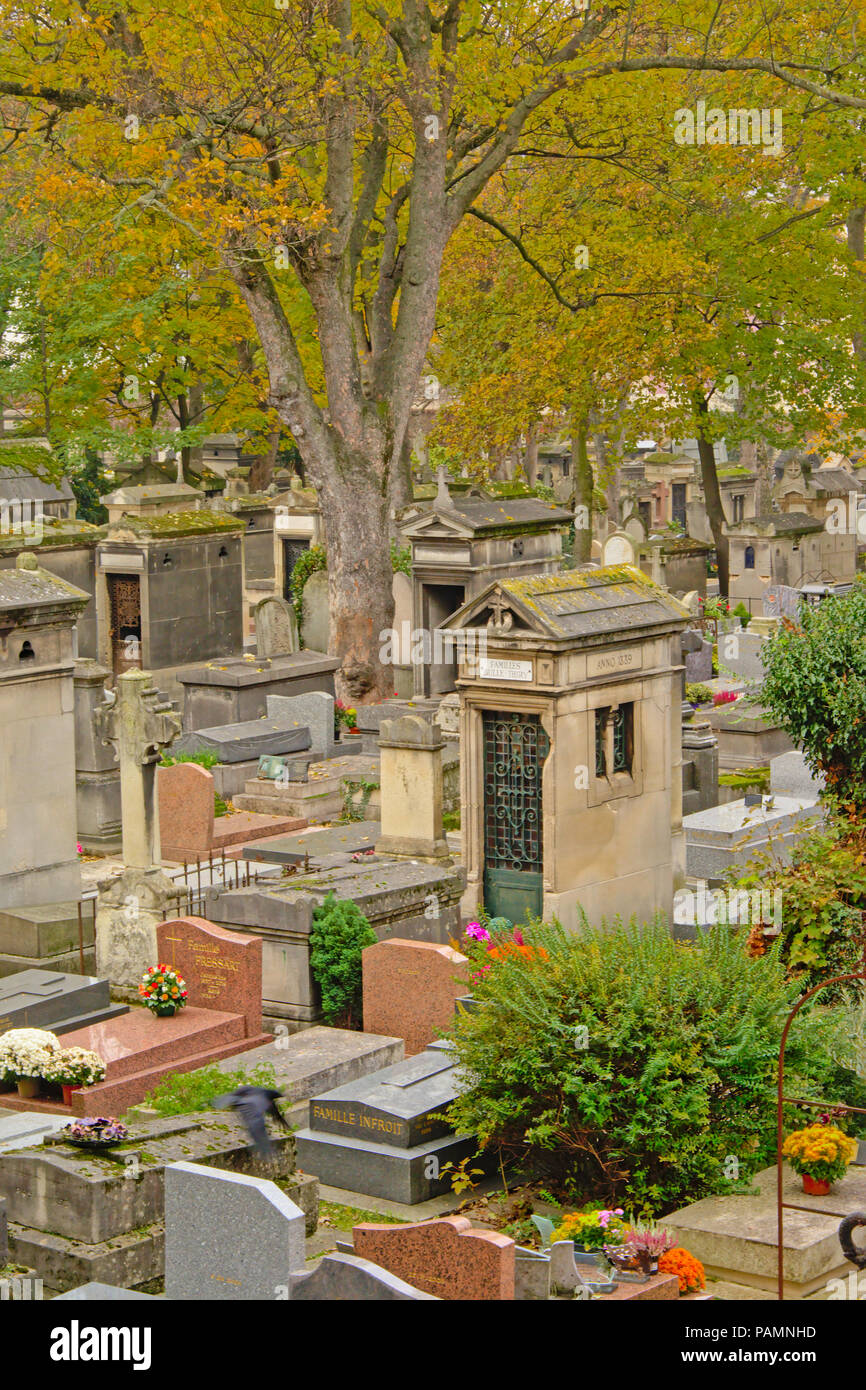old worn grave tombs with autumn trees in Mont martre cemetery, Paris ...
