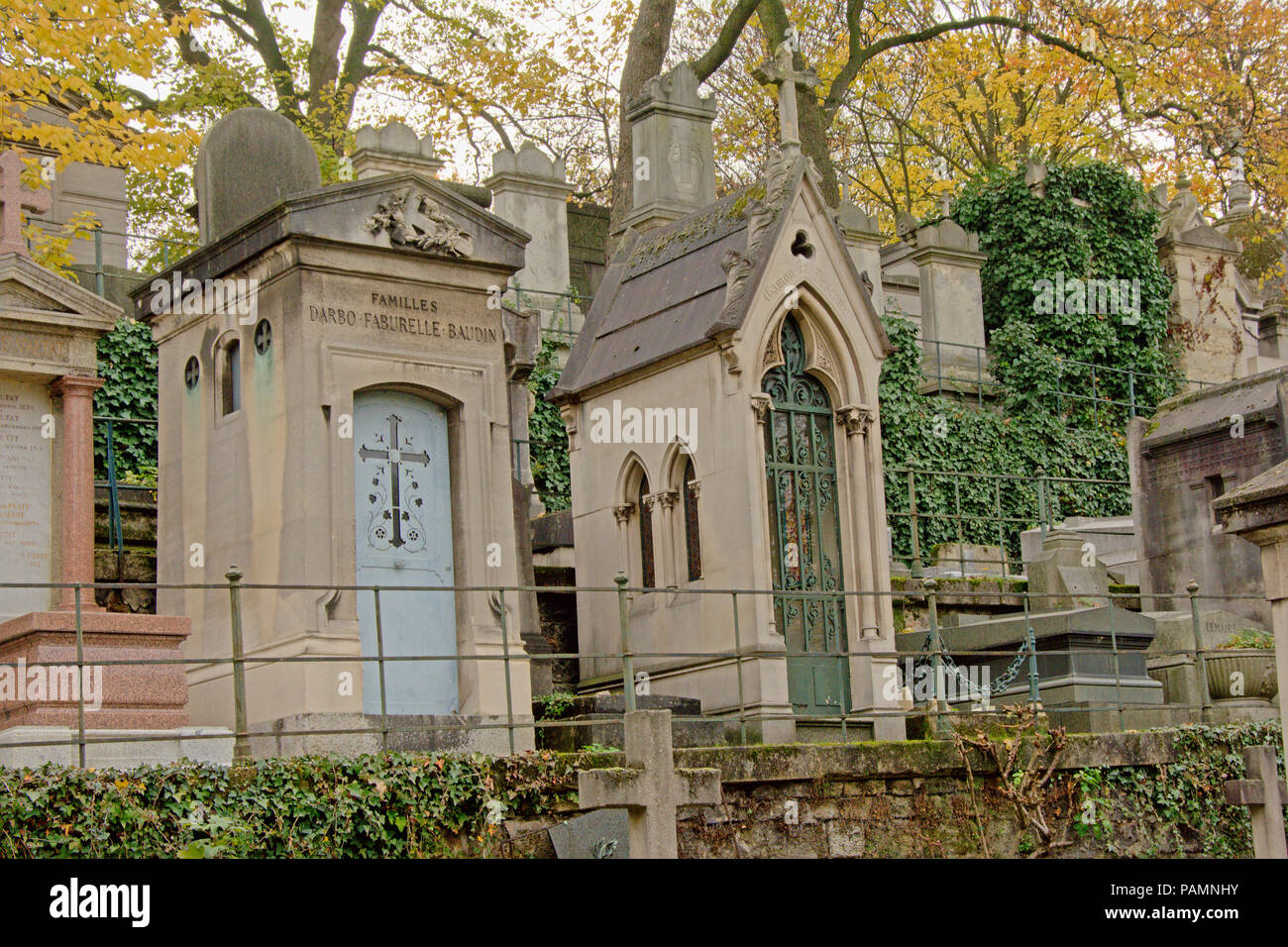 Old grave monuments and autumn trees in Montmartre cemetery, Paris ...