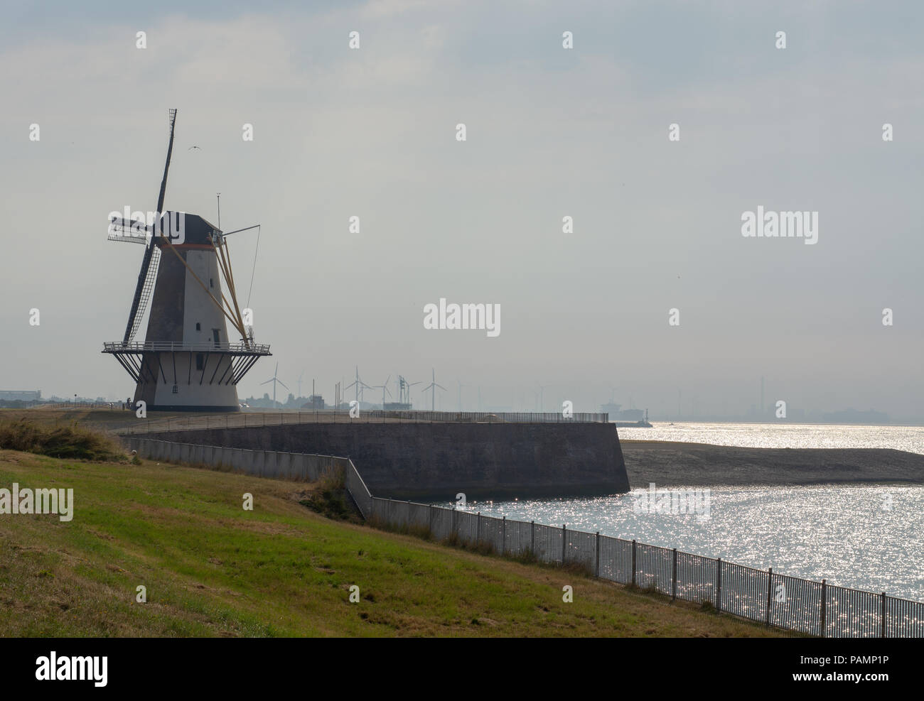 Tourist destination, traditional Dutch windmill on sea shore ...