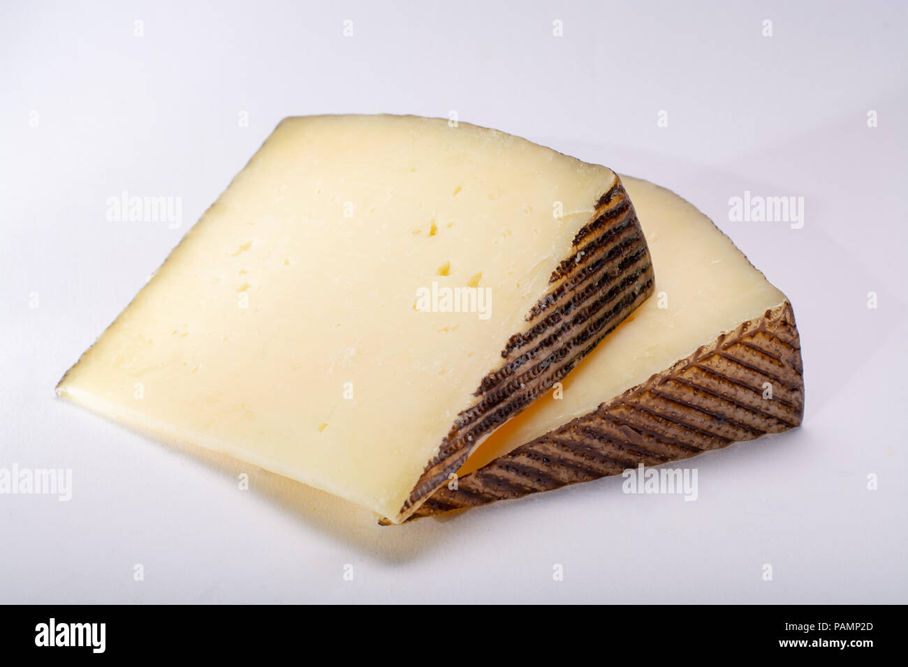 Two pieces of Manchego, queso manchego, cheese made in La Mancha region ...